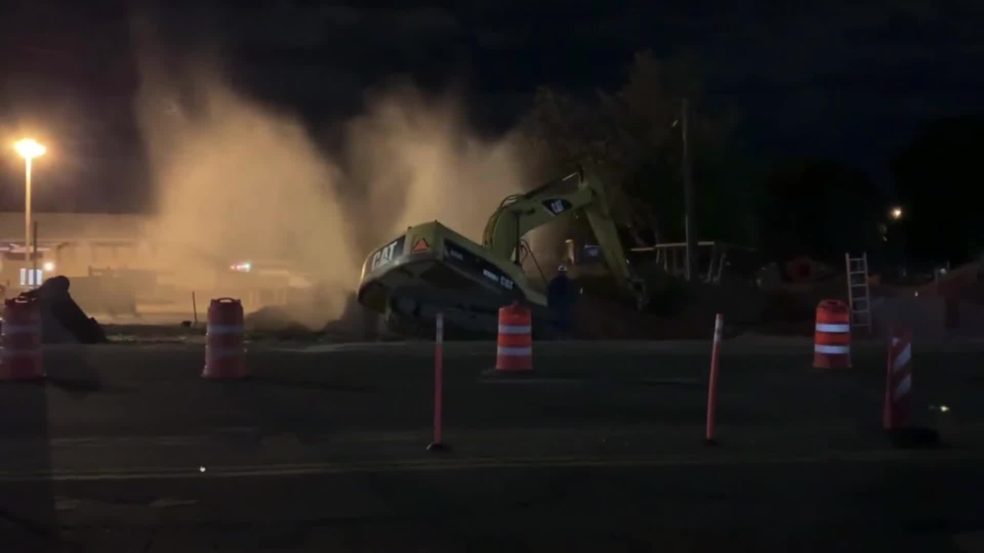 Unoccupied excavator crashes into hole, causes water main break – FOX31 ...